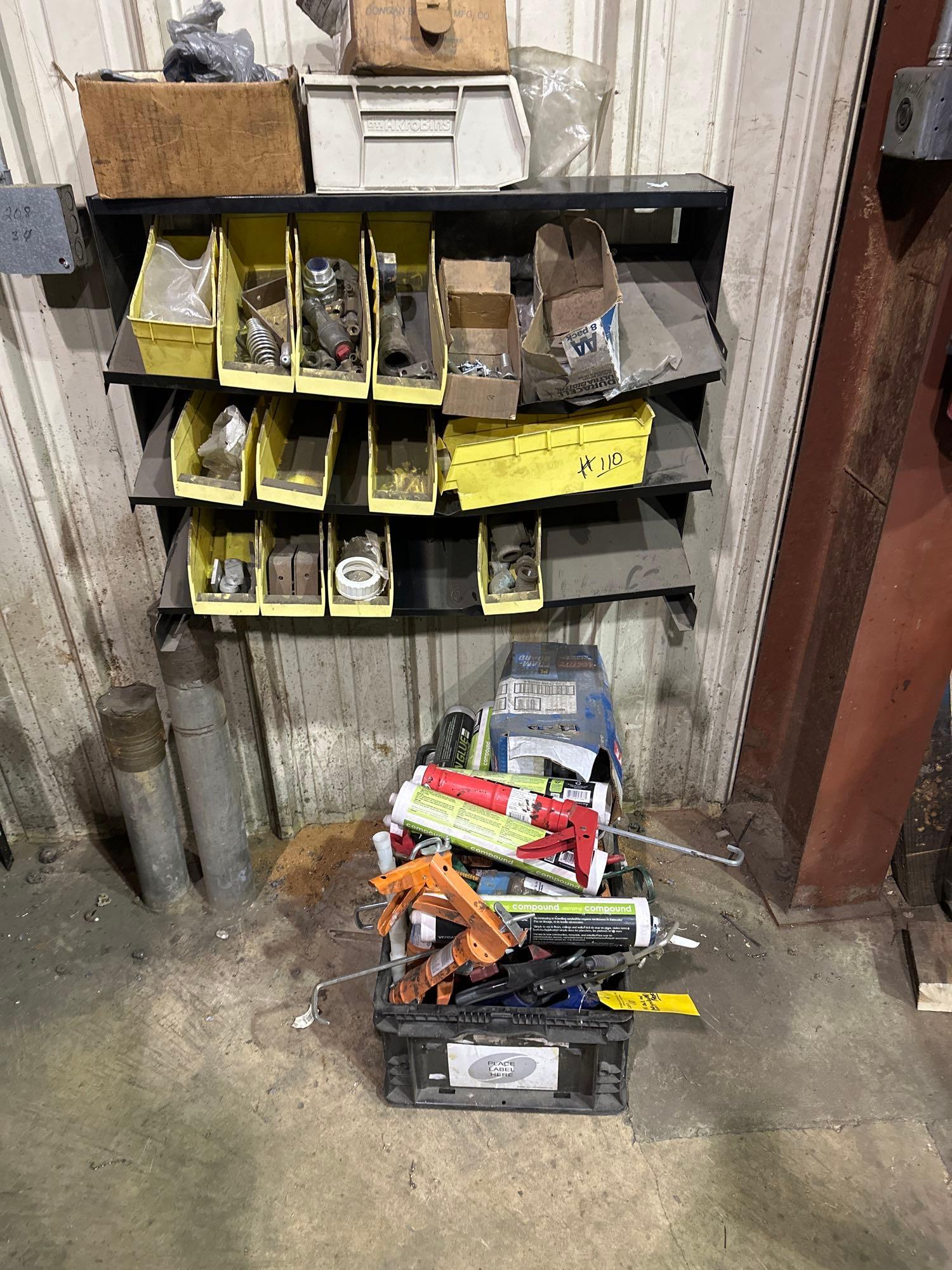 Wall rack, caulk, guns, and caulking all one lot | Proxibid