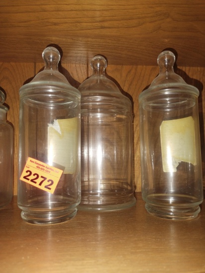set of three vintage clear glass apothecary jars with lids, likely part ...
