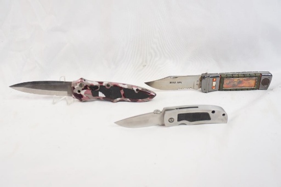 Three folding knives, one easy open switchblade type knife with 4 ...