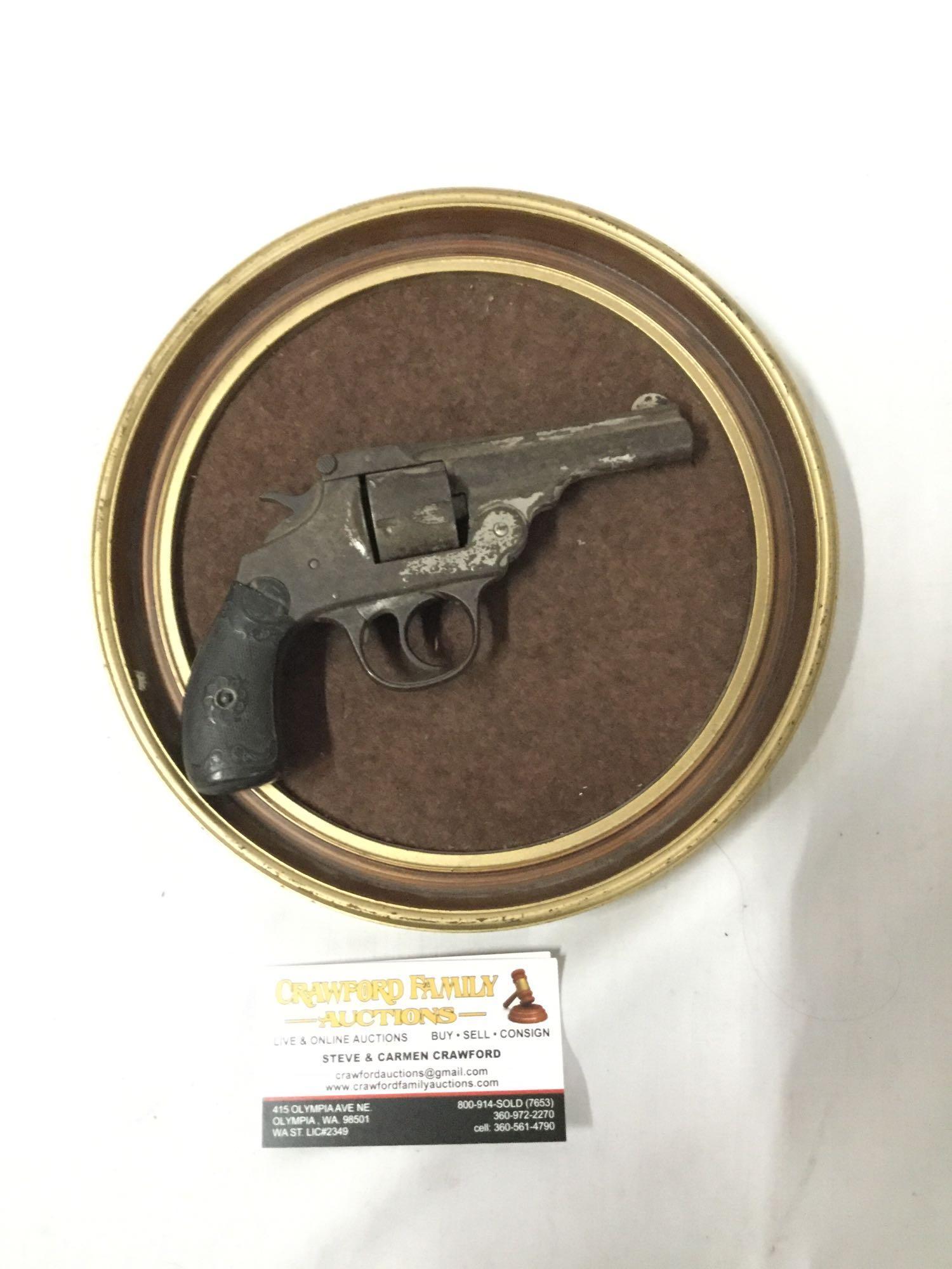 Antique revolver mounted on a wall plate | Proxibid